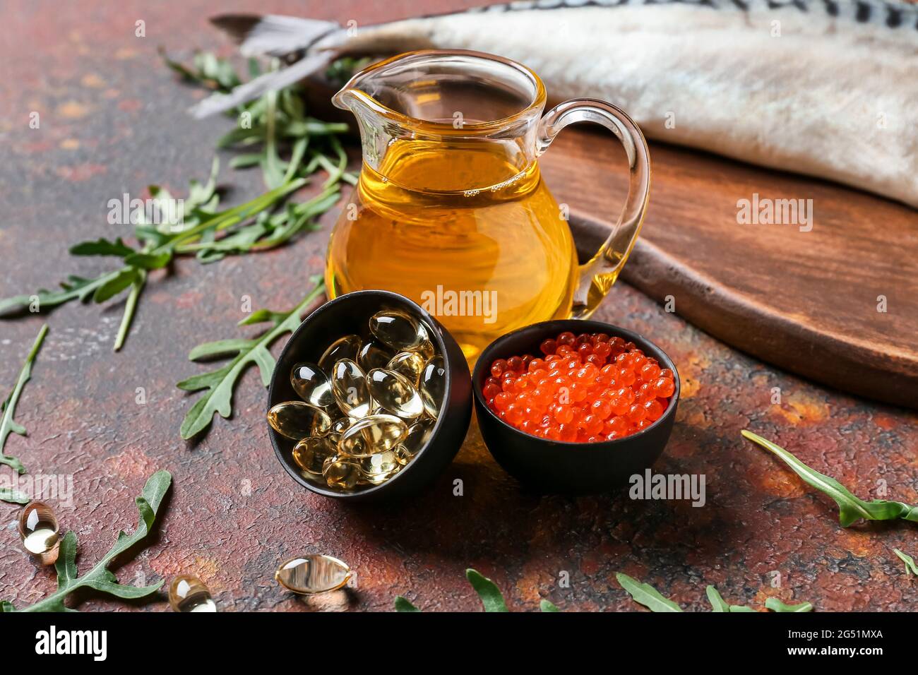 Tasty red caviar, pills, fish and oil on grunge background Stock Photo ...