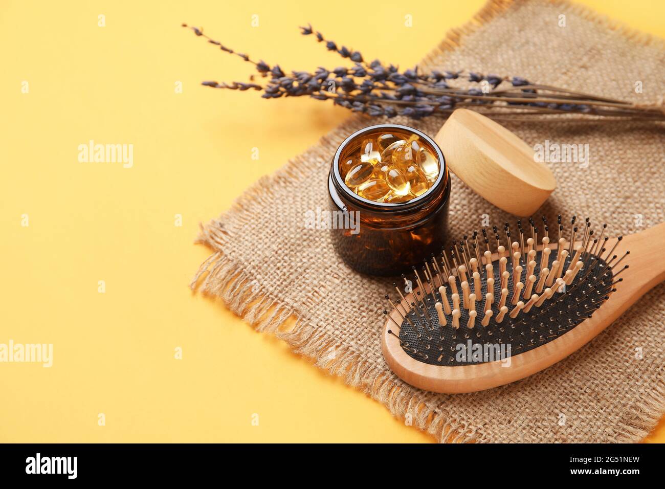 Hair brush, fish oil pills and lavender on color background Stock Photo ...