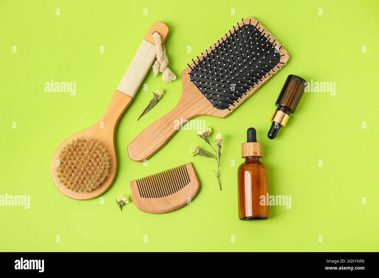 Composition with hair brush, comb and cosmetics on color background ...