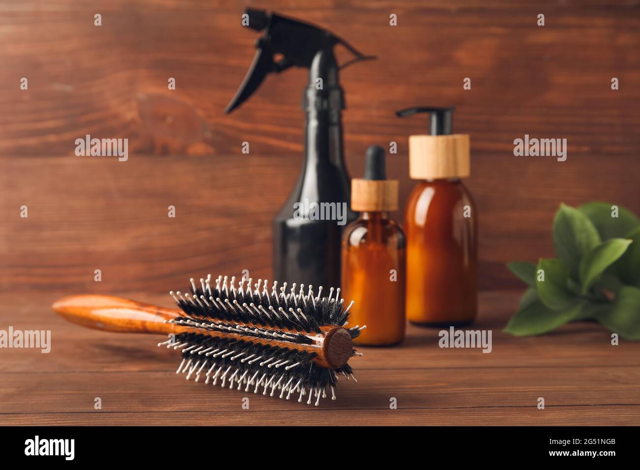 Hair brush and cosmetics on wooden background Stock Photo - Alamy