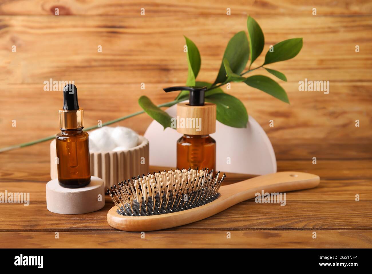 Hair brush and cosmetics on wooden background Stock Photo - Alamy