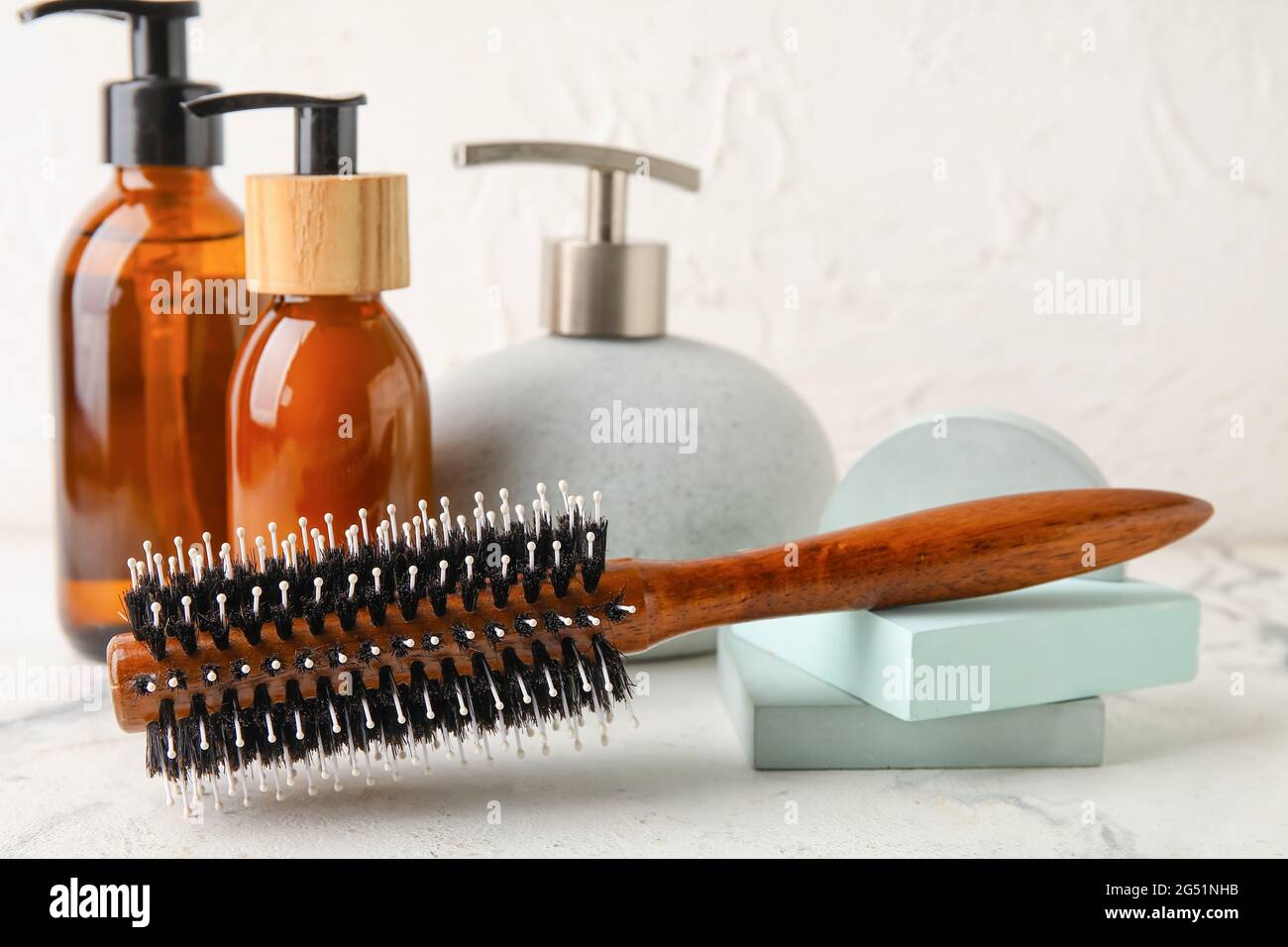 Hair brush and cosmetics on light background Stock Photo - Alamy