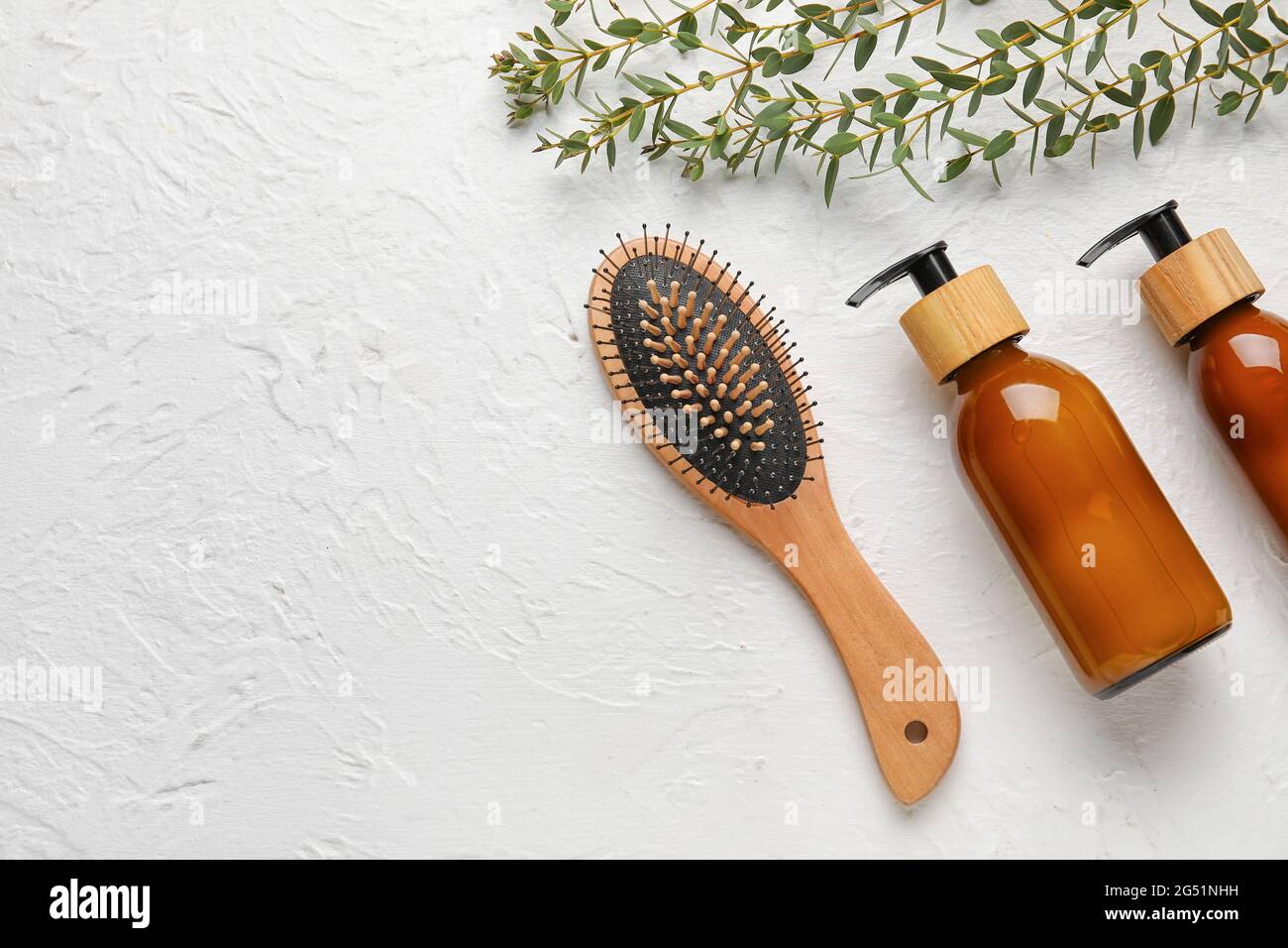 Hair brush and cosmetics on light background Stock Photo - Alamy