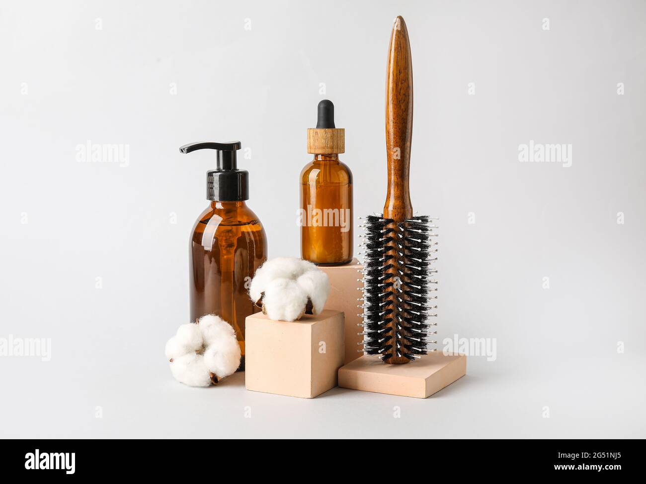 Hair brush and cosmetics on light background Stock Photo - Alamy