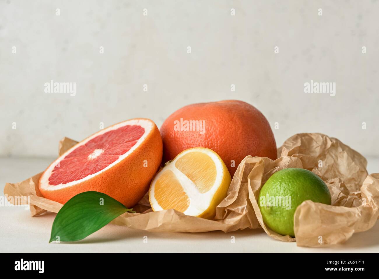 Healthy citrus fruits on light background Stock Photo - Alamy