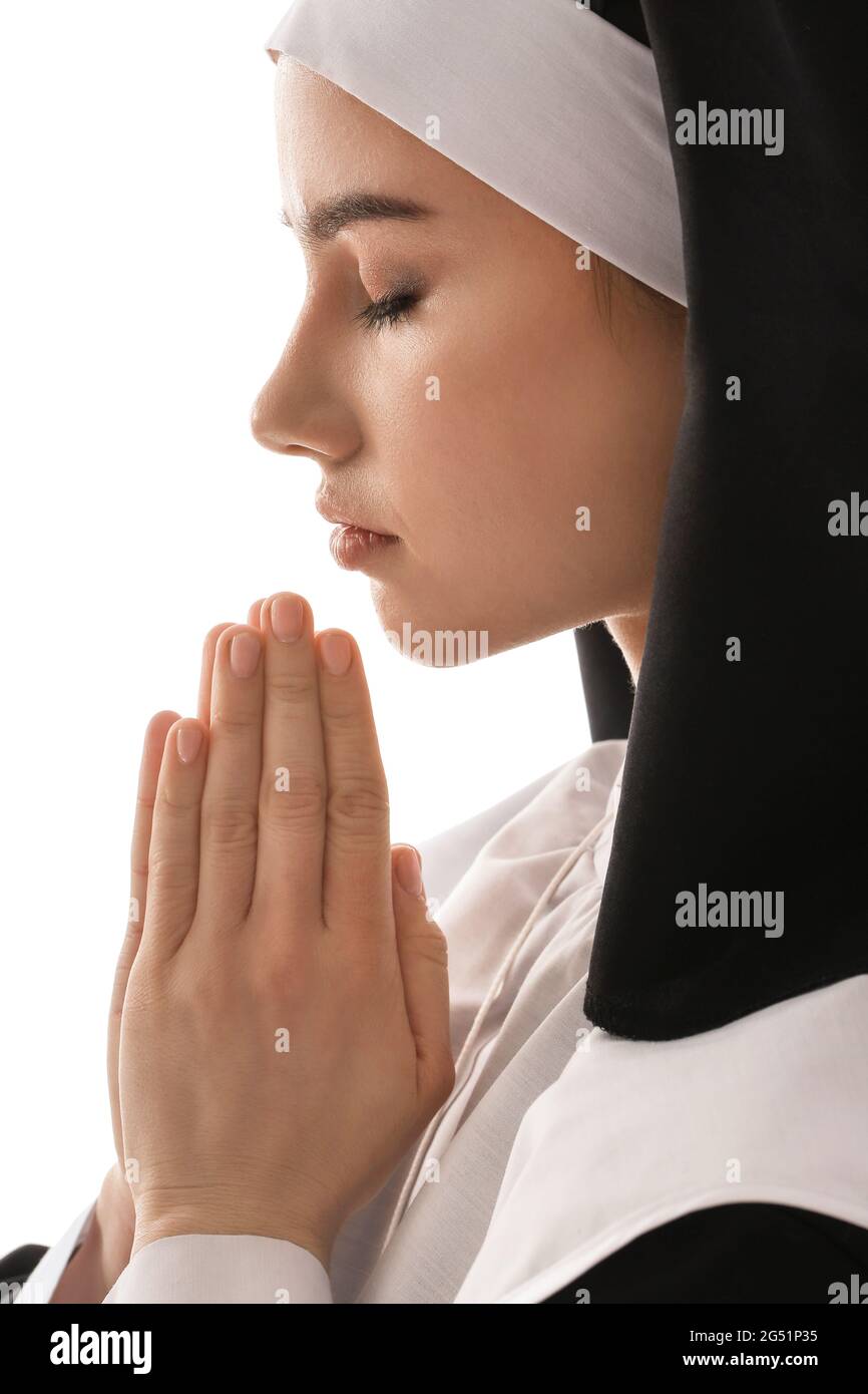 Young praying nun on white background Stock Photo - Alamy