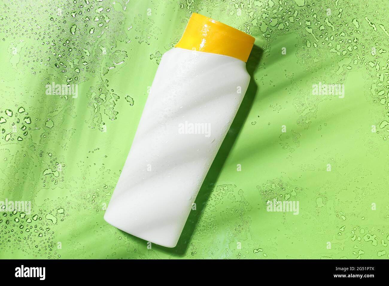 Bottle of sunscreen on color background with water drops Stock Photo ...