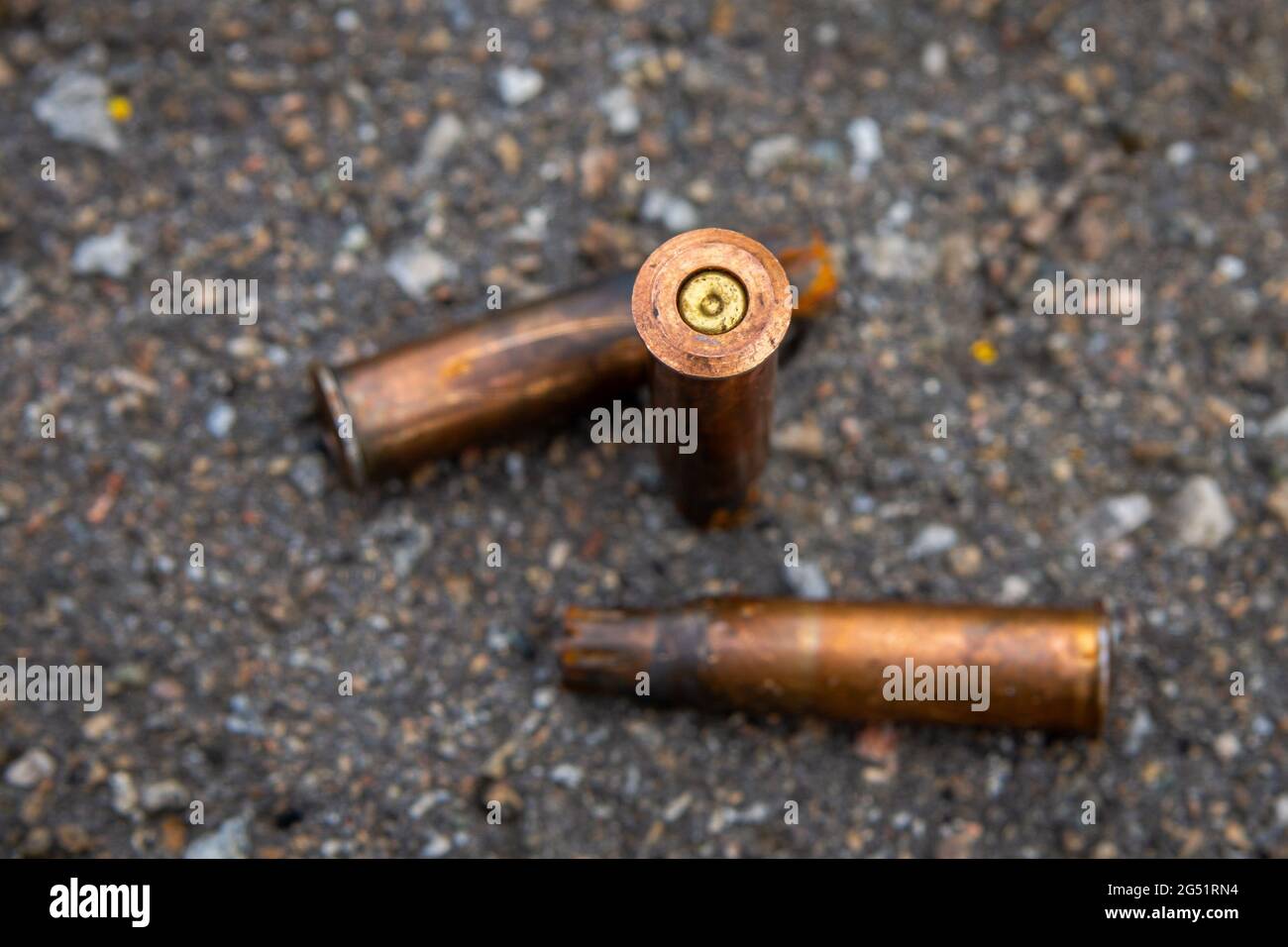 Three old brown bullet casings close up Stock Photo - Alamy