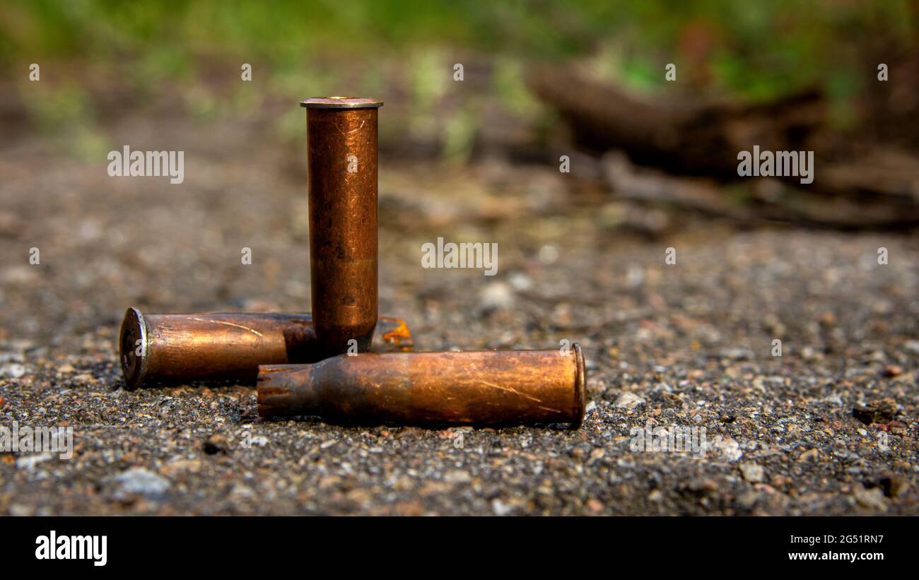 Three old brown bullet casings close up Stock Photo - Alamy