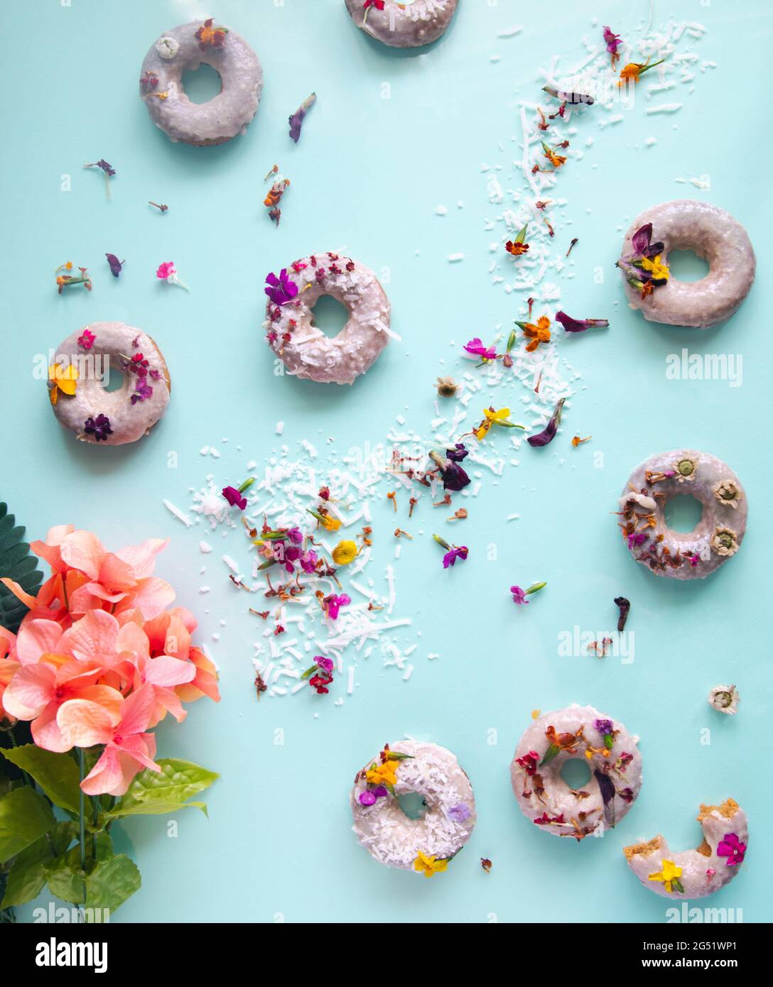 Colorful donuts with edible flowers Stock Photo - Alamy
