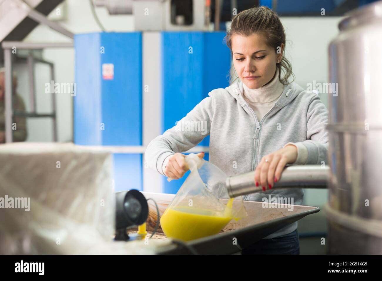 Woman controlling process of oil decanting Stock Photo - Alamy
