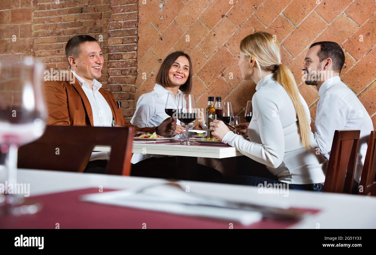 Group of people dining out merrily in country restaurant Stock Photo ...