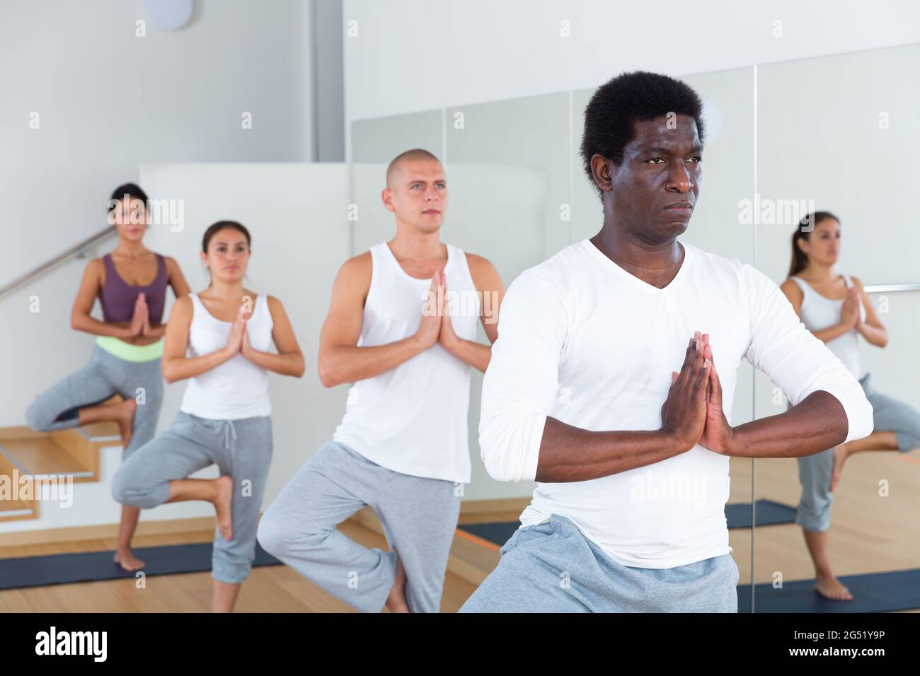 People studying new position at yoga school Stock Photo - Alamy