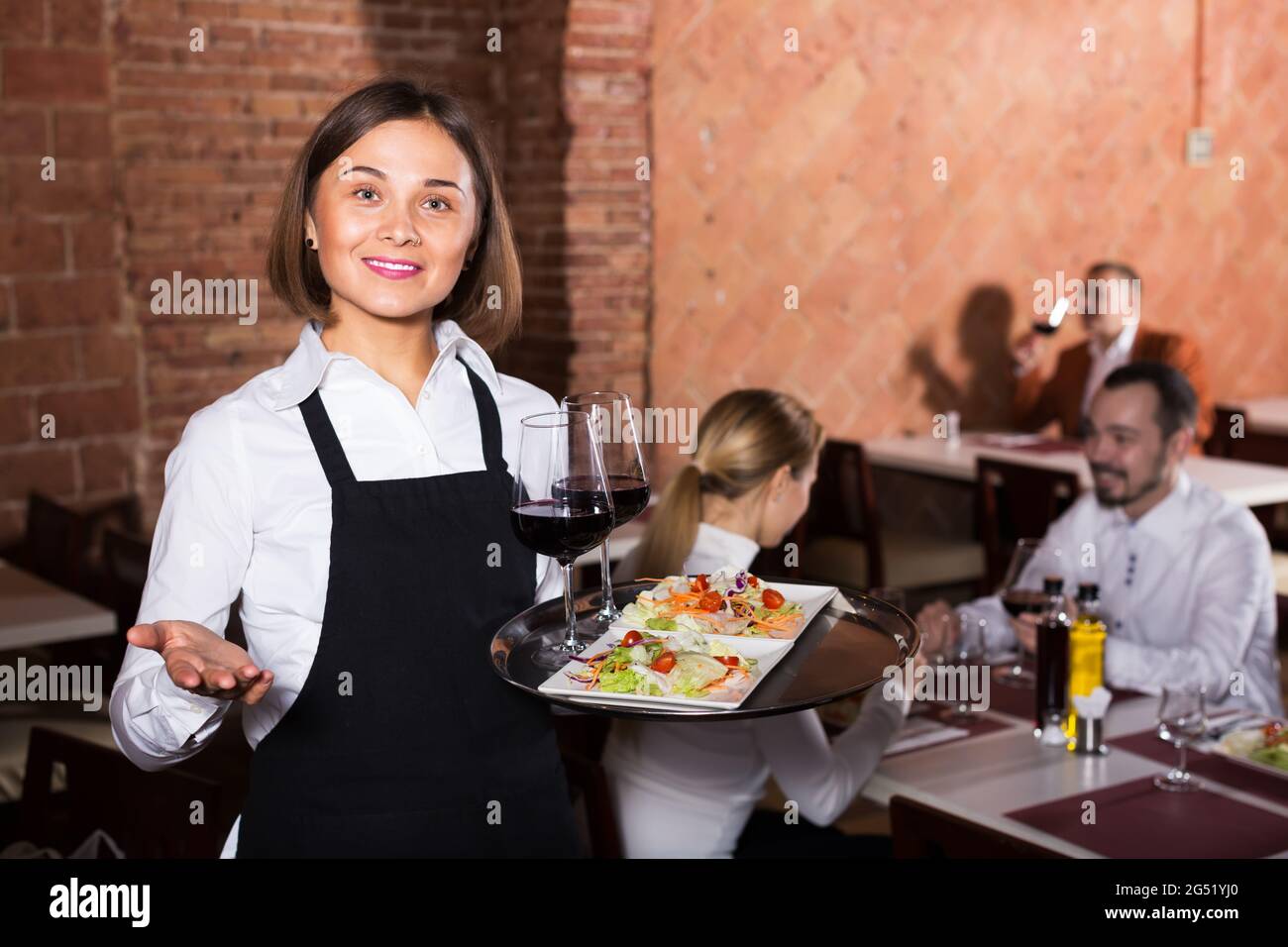 Female waiter in country restaurant Stock Photo - Alamy
