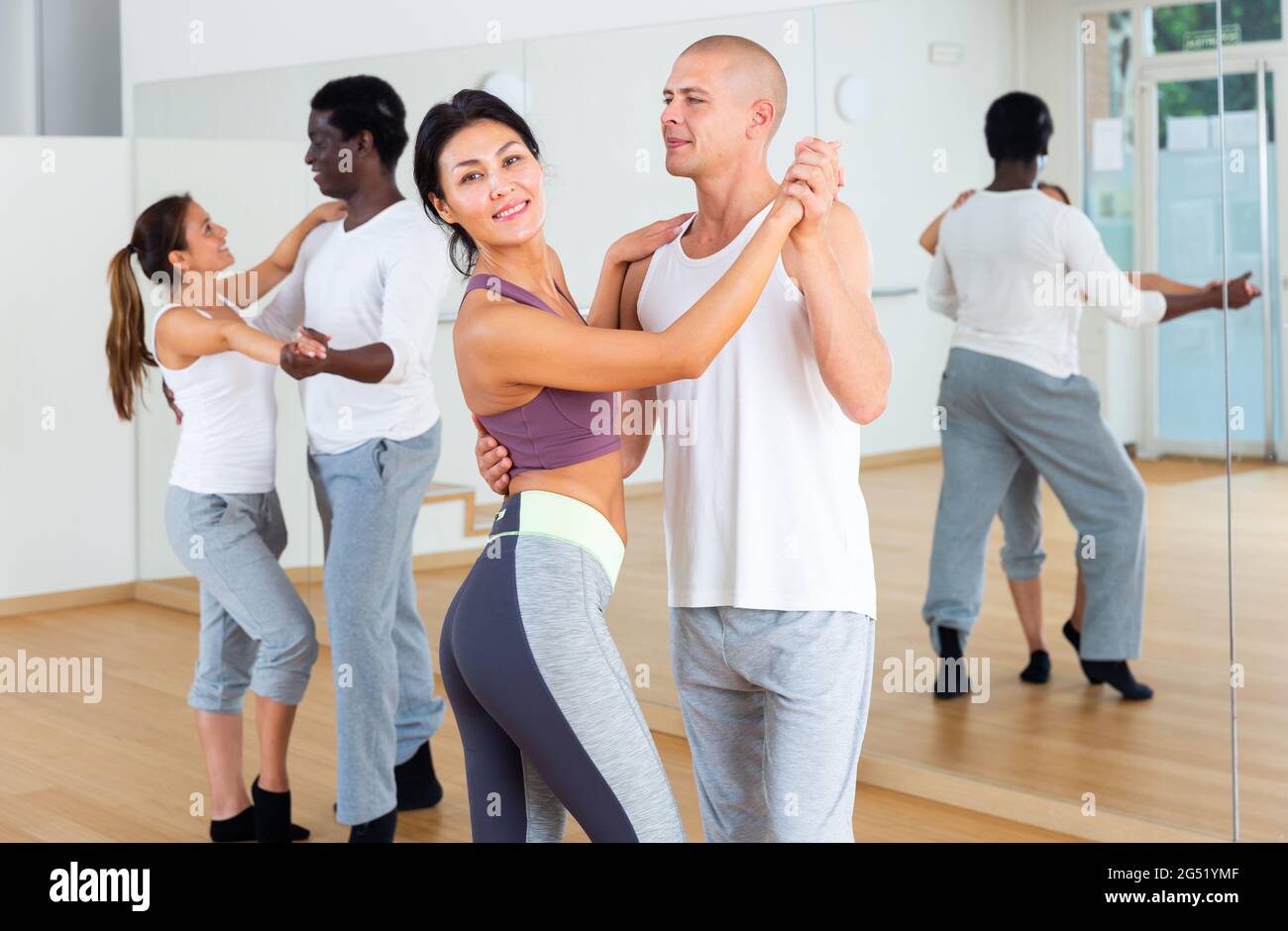 Young couples practicing active dance in pair Stock Photo - Alamy