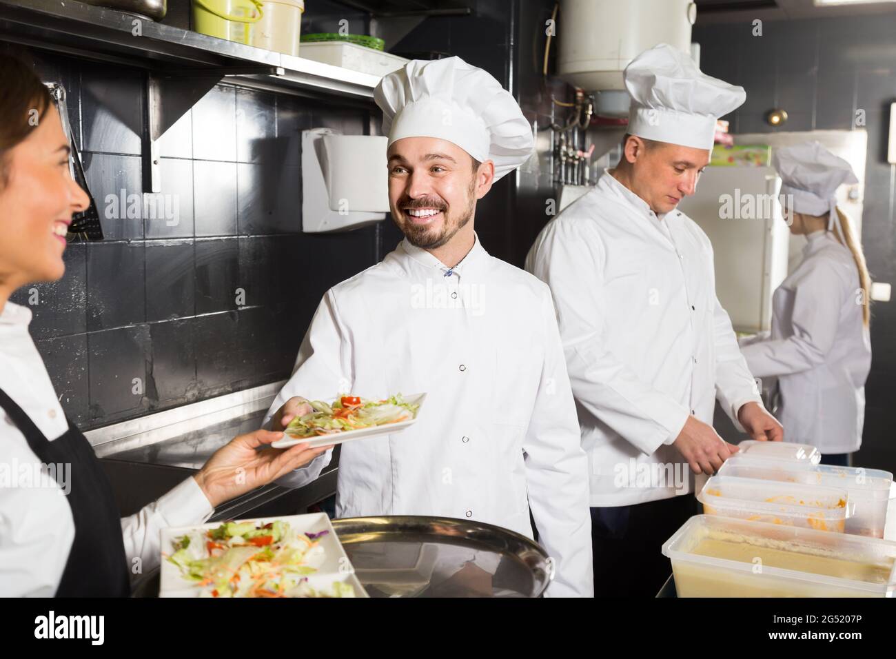 Female waiter taking ordered dishes Stock Photo - Alamy