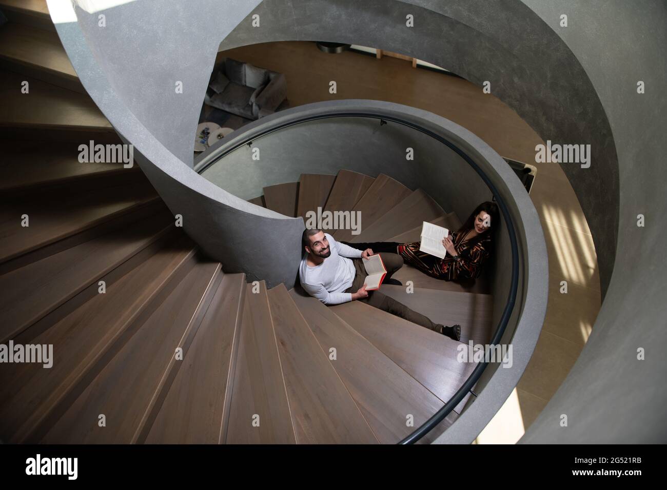 Two College Students Reading Books on Spiral Stairs Architecture Art ...