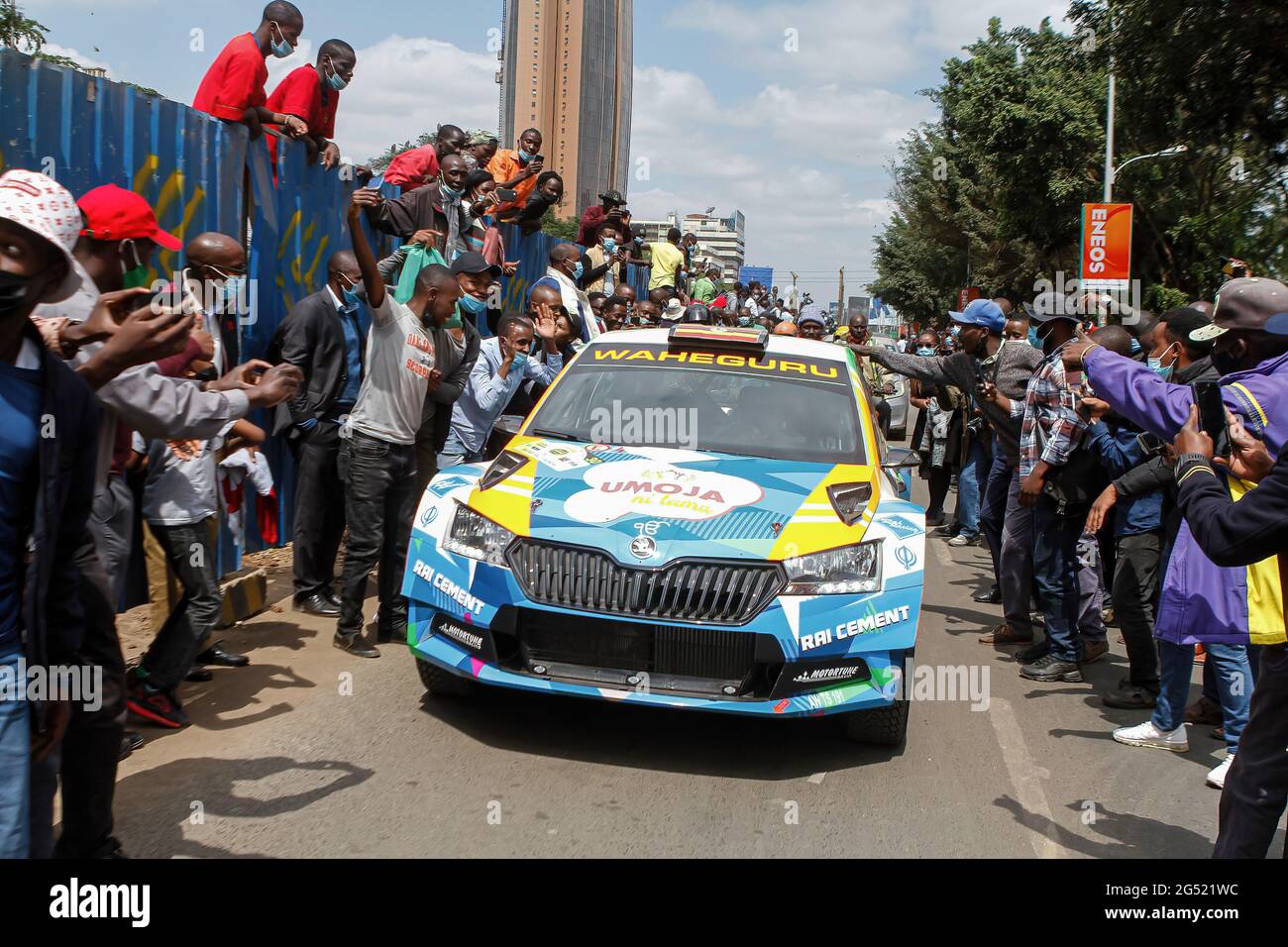 Kenyan spectators surround one of the safari rally racing cars along ...