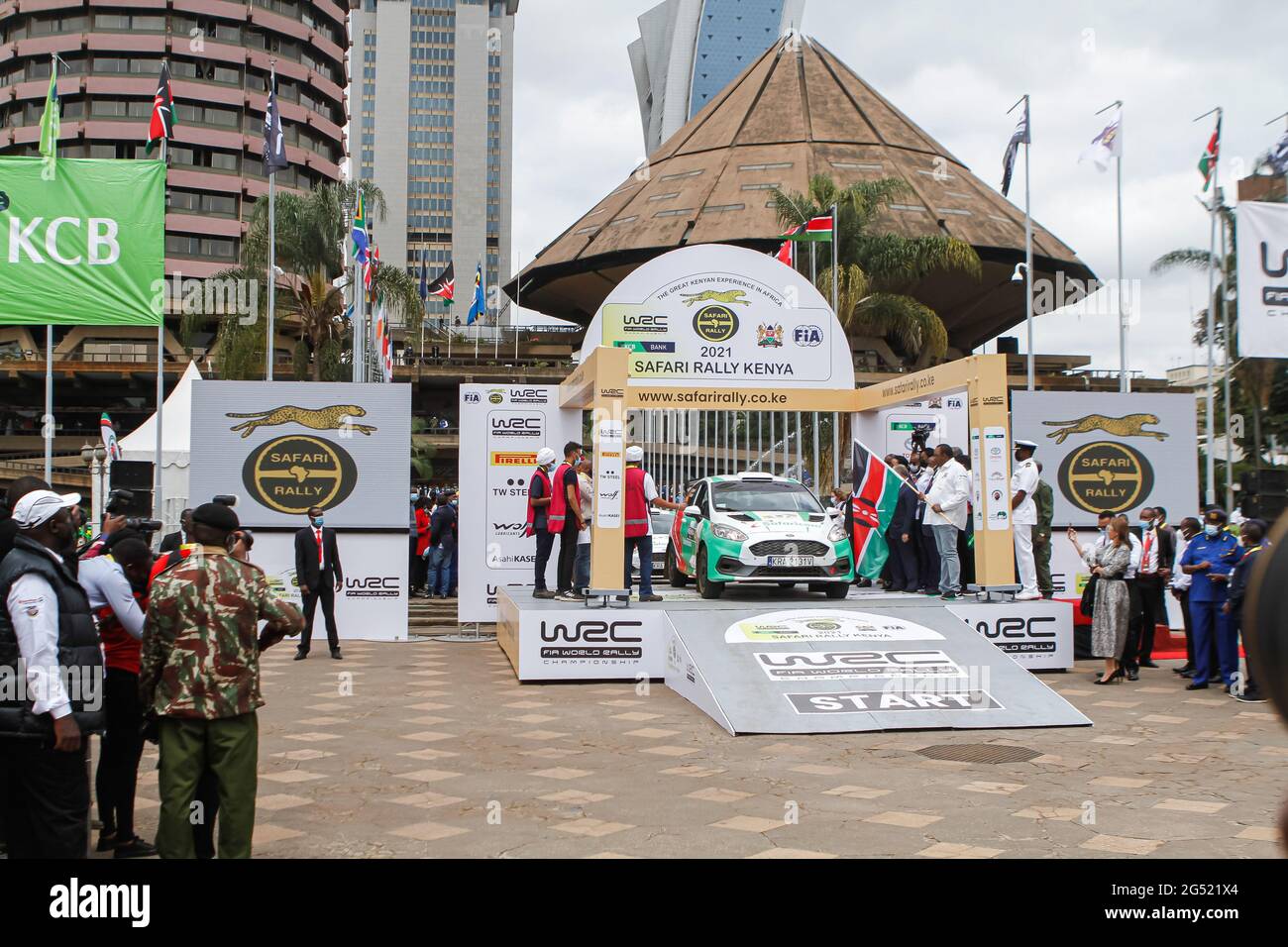 Kenya's President Uhuru Kenyatta (R) flags off Kenyan driver Hamza ...