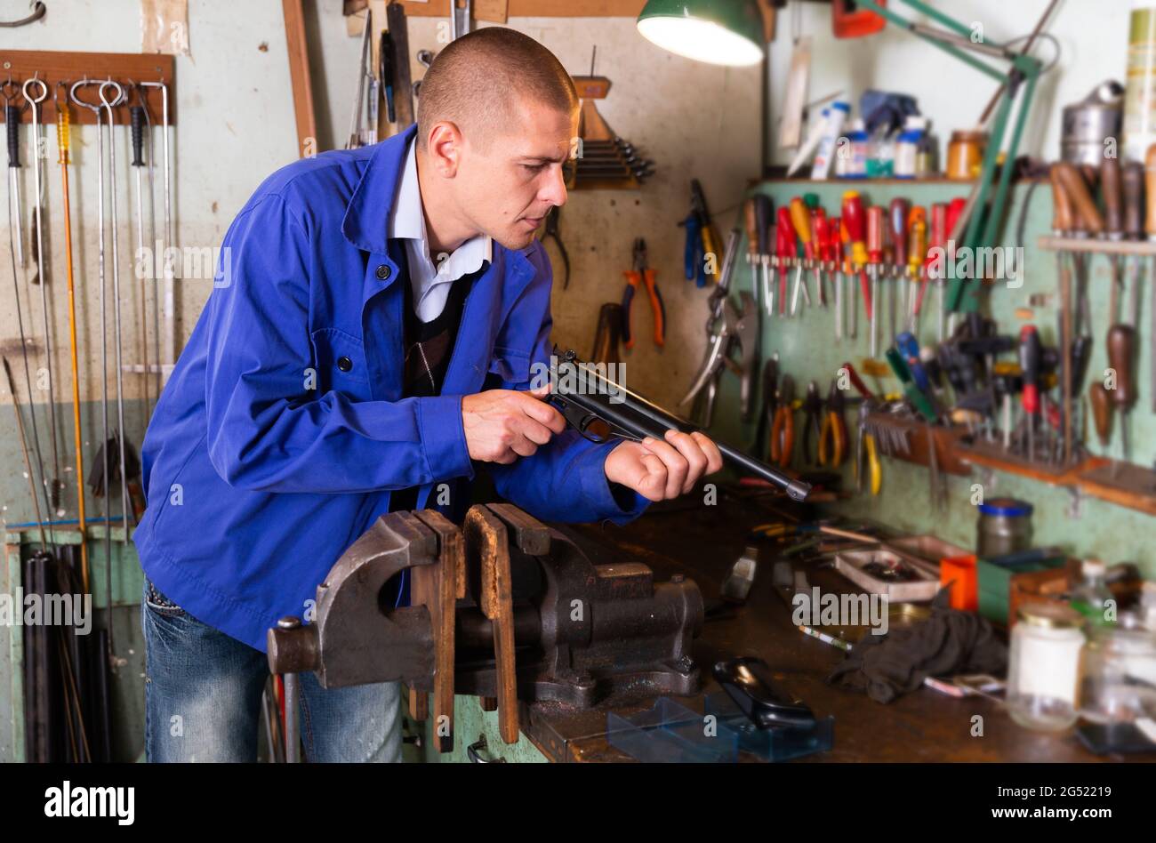 Repair and lubrication of pistol in weapons workshop Stock Photo - Alamy