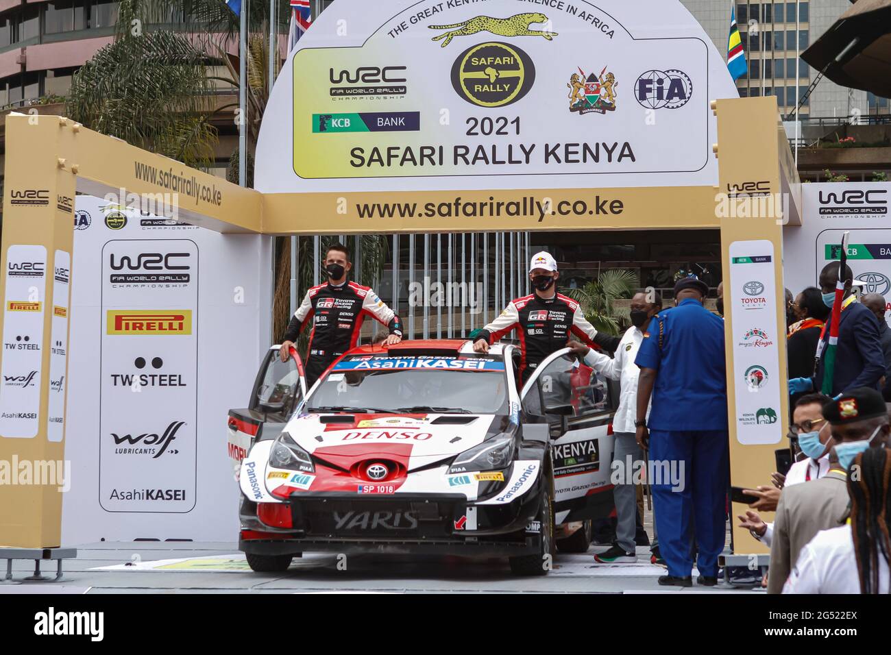 Kenya's President Uhuru Kenyatta (R) prepares to flag off Elfyn Evans ...