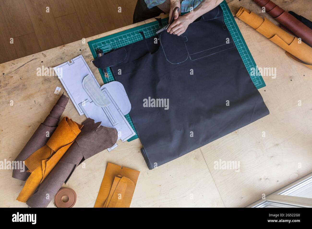 Craftsman drawing scheme lining for bag on tissue creating leatherwork ...