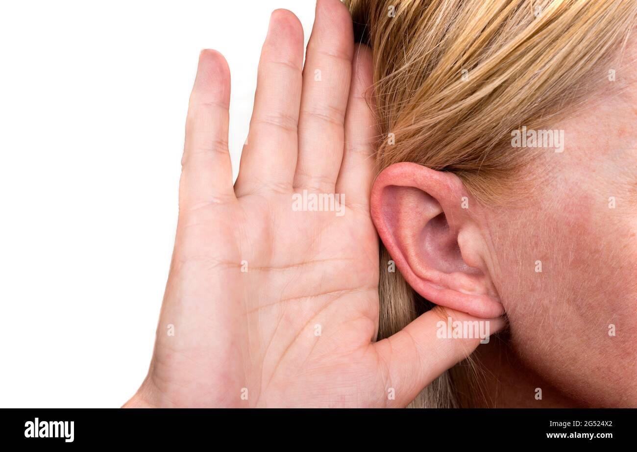 Woman is touching the ear to listen better Stock Photo - Alamy
