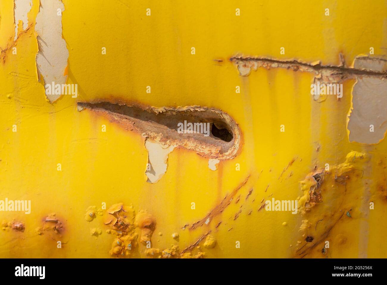 Rust.An old metal product with rust spots and fallen off yellow paint ...