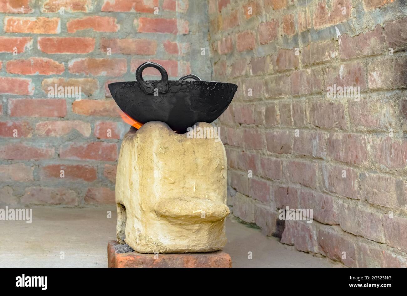 Traditional Indian Chulha aka stove in flame with Black cauldron and ...