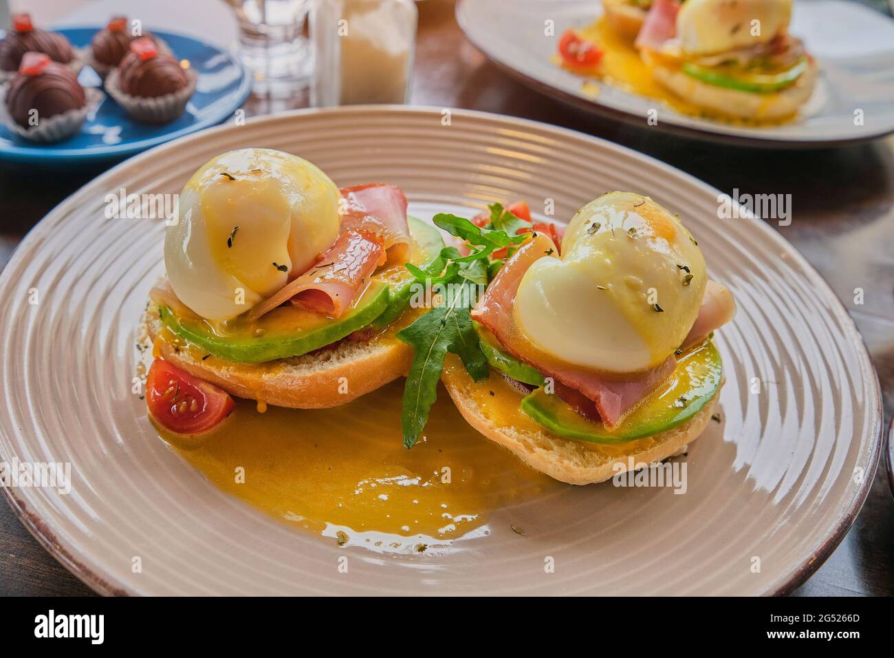 Eggs Benedict on toasted muffins with ham, poached egg and hollandaise ...