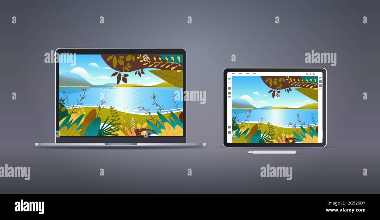 graphic tablet and laptop with beautiful landscape wallpapers on ...