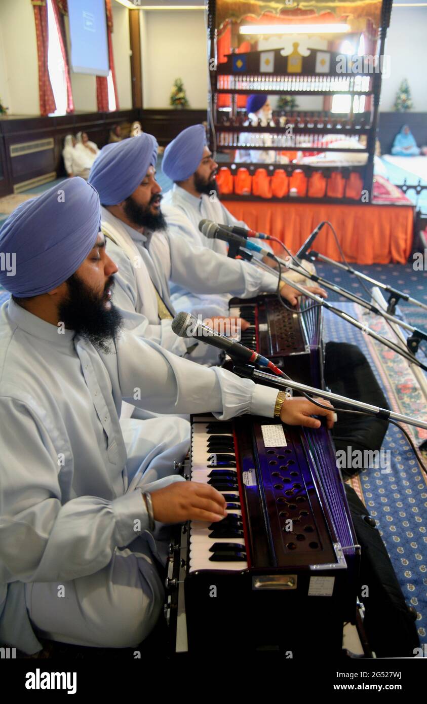 Sikh rajis playing shabads from the Guru Granth Sahib in the gurdwara ...