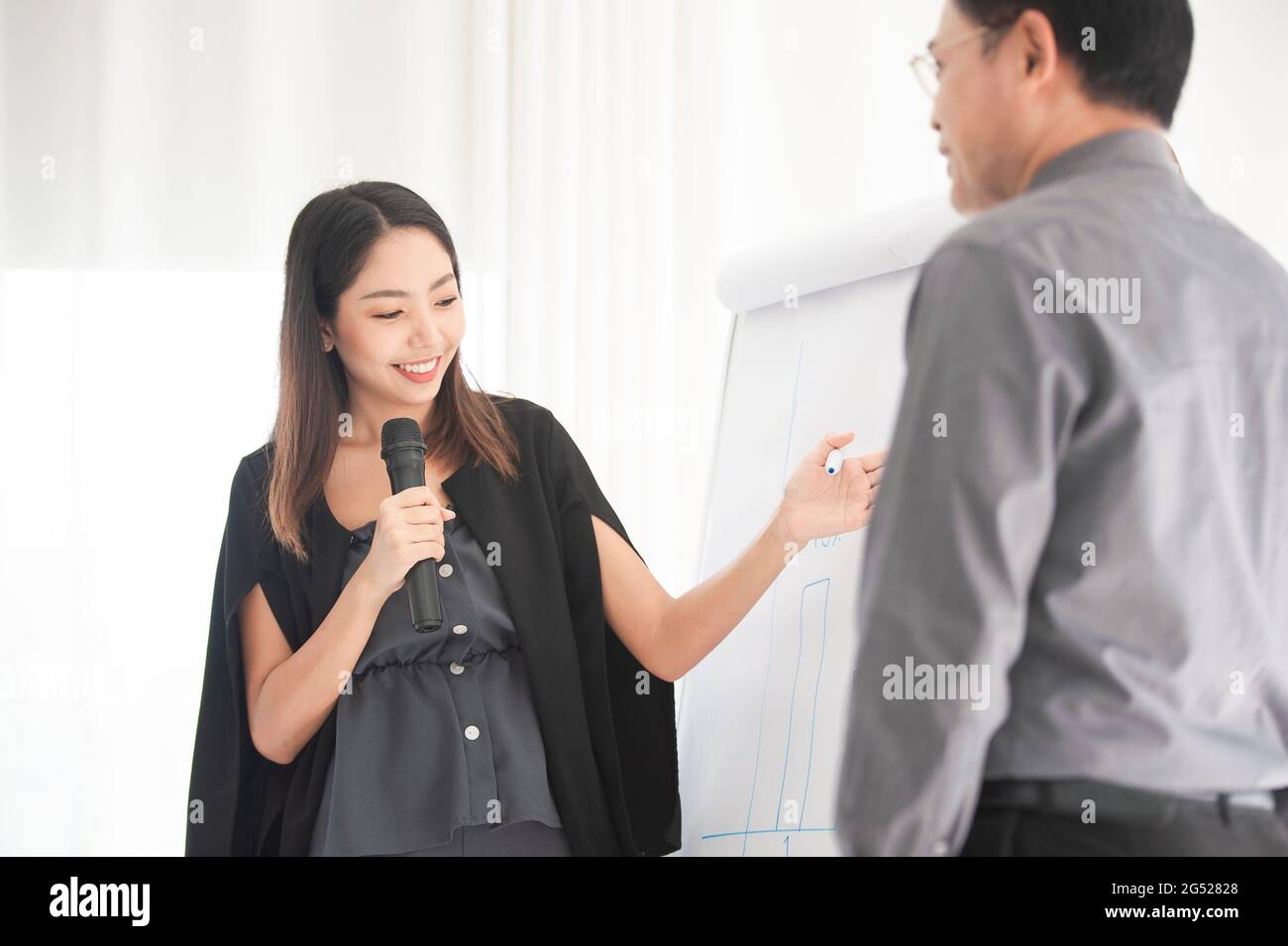 Businesswoman talking microphone present business plan in meeting room ...