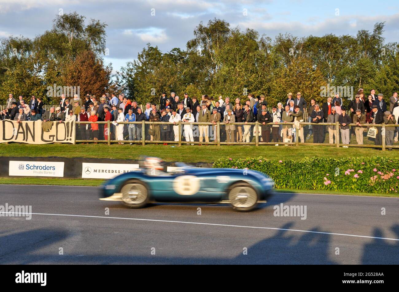 A classic racing car passing at speed the spectators at the Goodwood ...