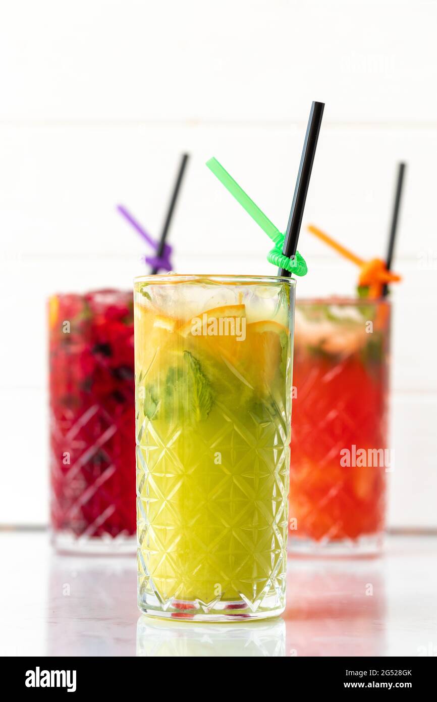 Three different refreshing lemonades on white wooden background Stock ...