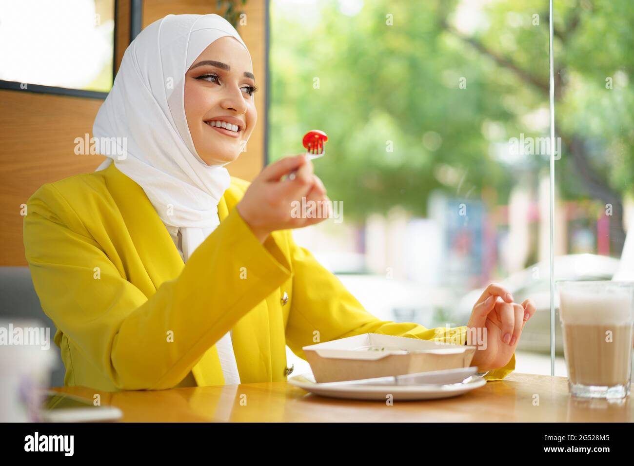 Woman eating table head scarf hi-res stock photography and images - Alamy