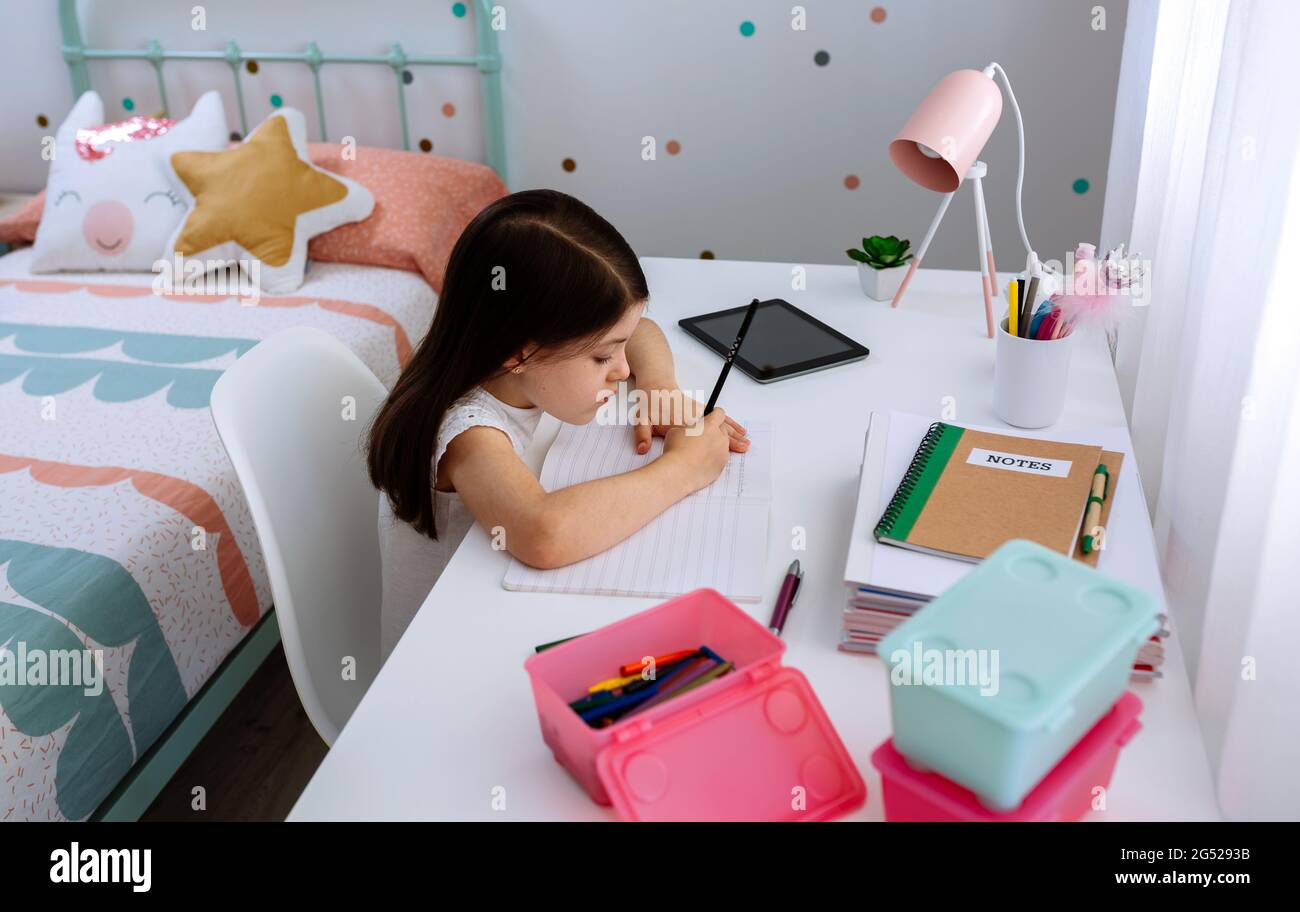 Girl doing homework in her bedroom Stock Photo - Alamy