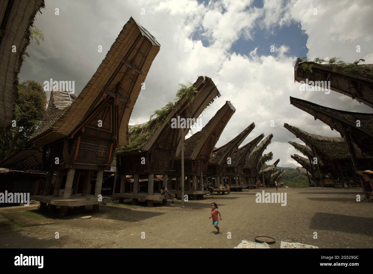 A child running on the main road in tourism village of Palawa in North ...
