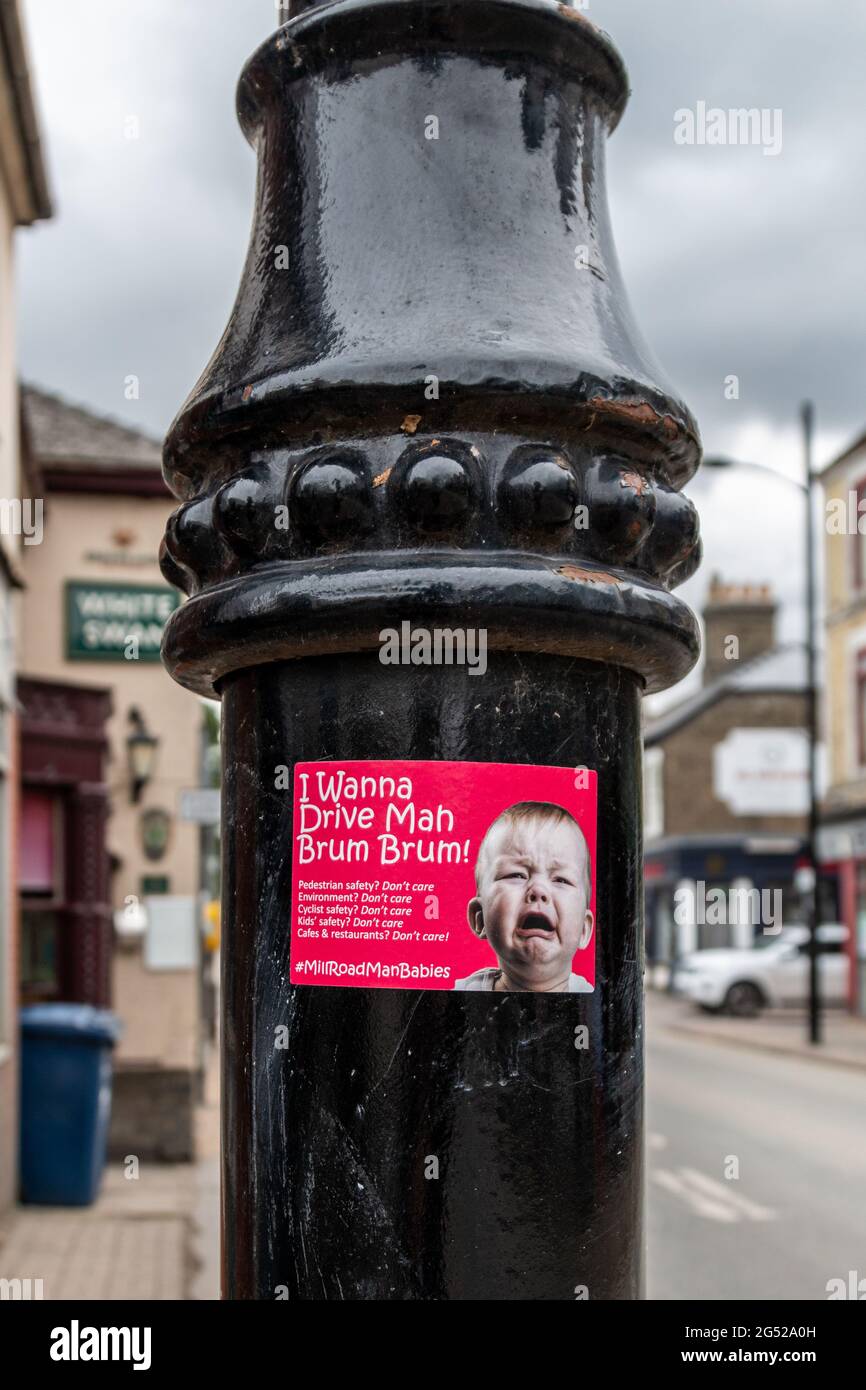 A red anti-car sticker comapares drivers to a crying baby on a lamp ...
