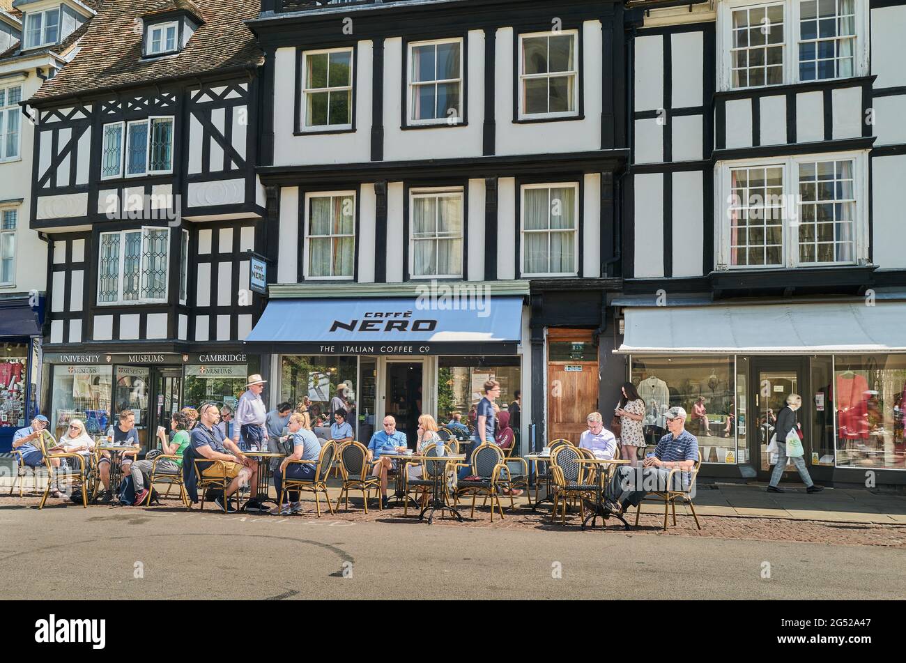 Customers relax at an outdoor café on King's Parade, Cambridge, England ...