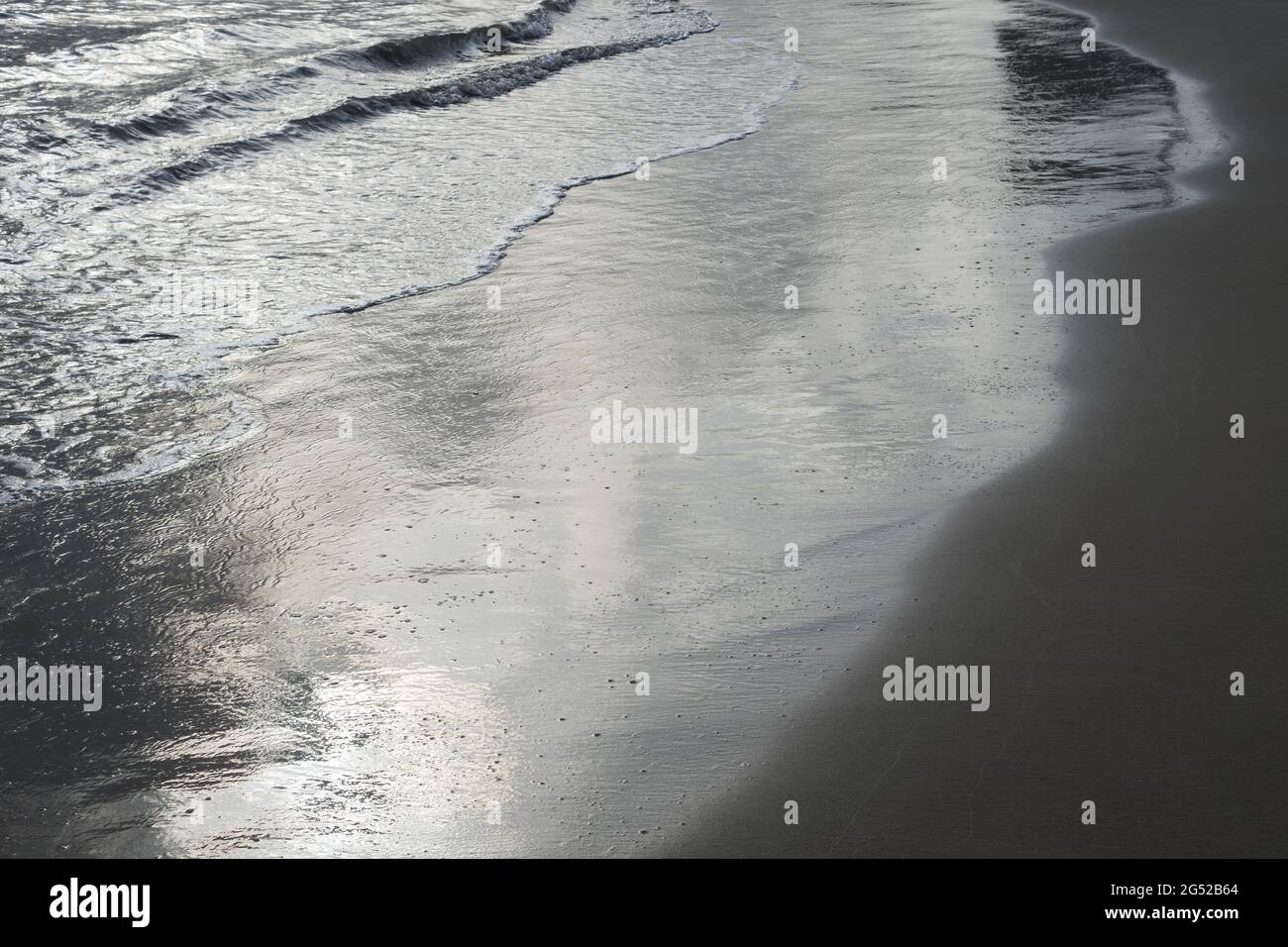 silver gray reflection on the beach water background Stock Photo - Alamy