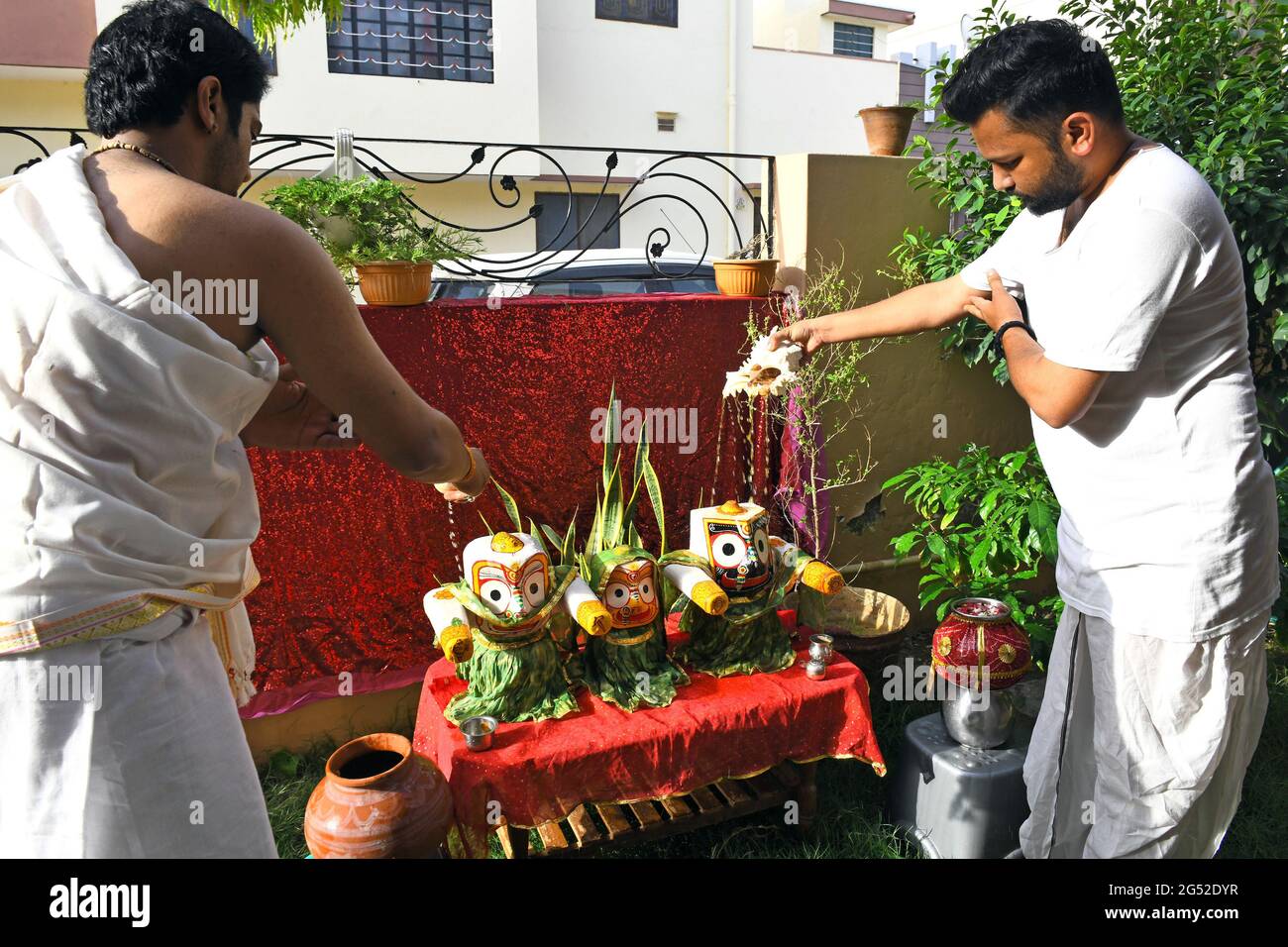 Hindu devotees pour water on idols of Lord Jagannath, his brother ...