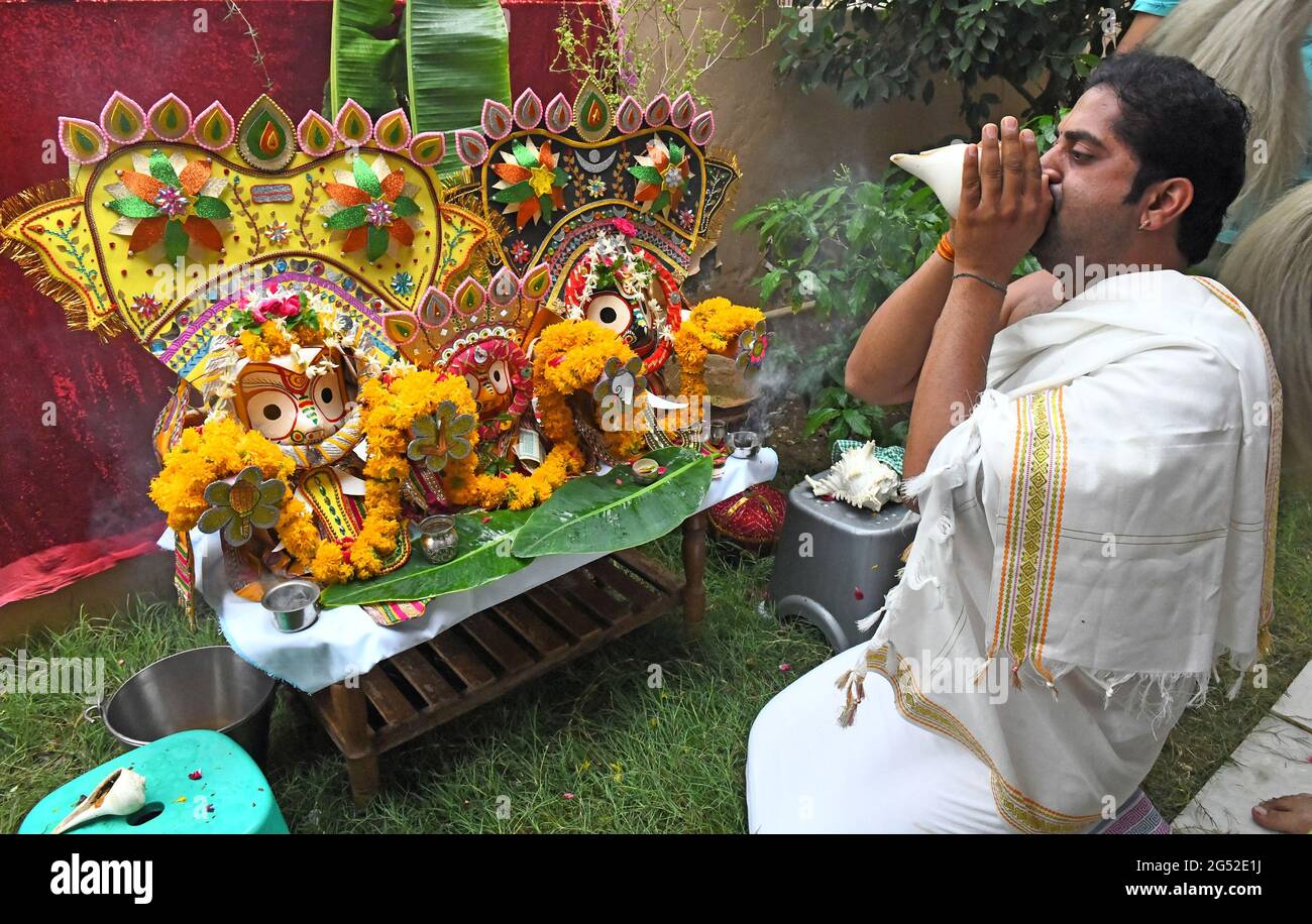 Hindu devotee blows a conch shell as he offer prayer to Lord Jagannath ...