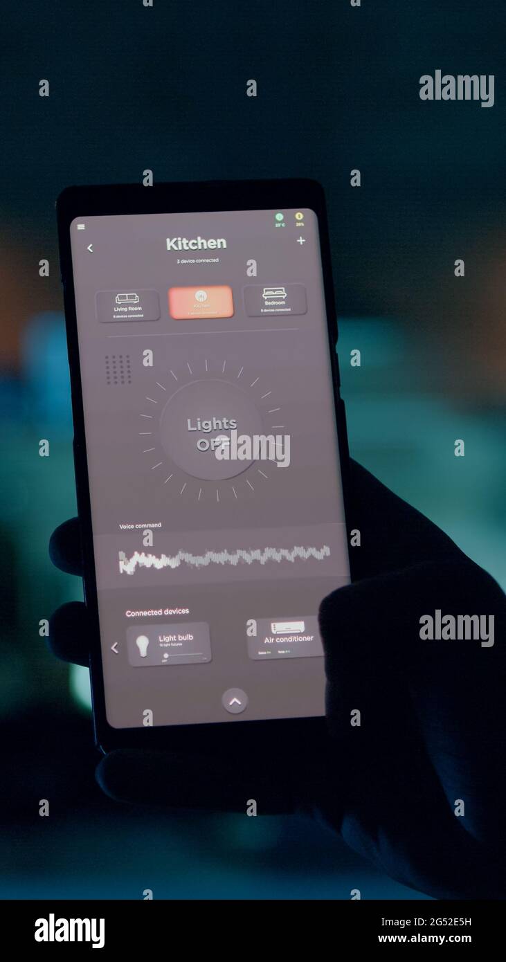 Person controlling house light using smart home application touching ...