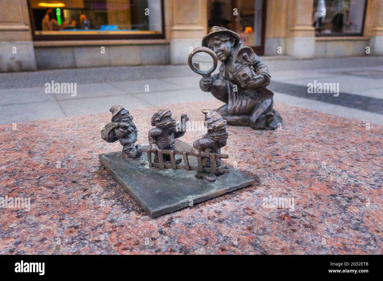 Wroclaw, Poland dwarf gnomes sculpture with magnifying glass in ...