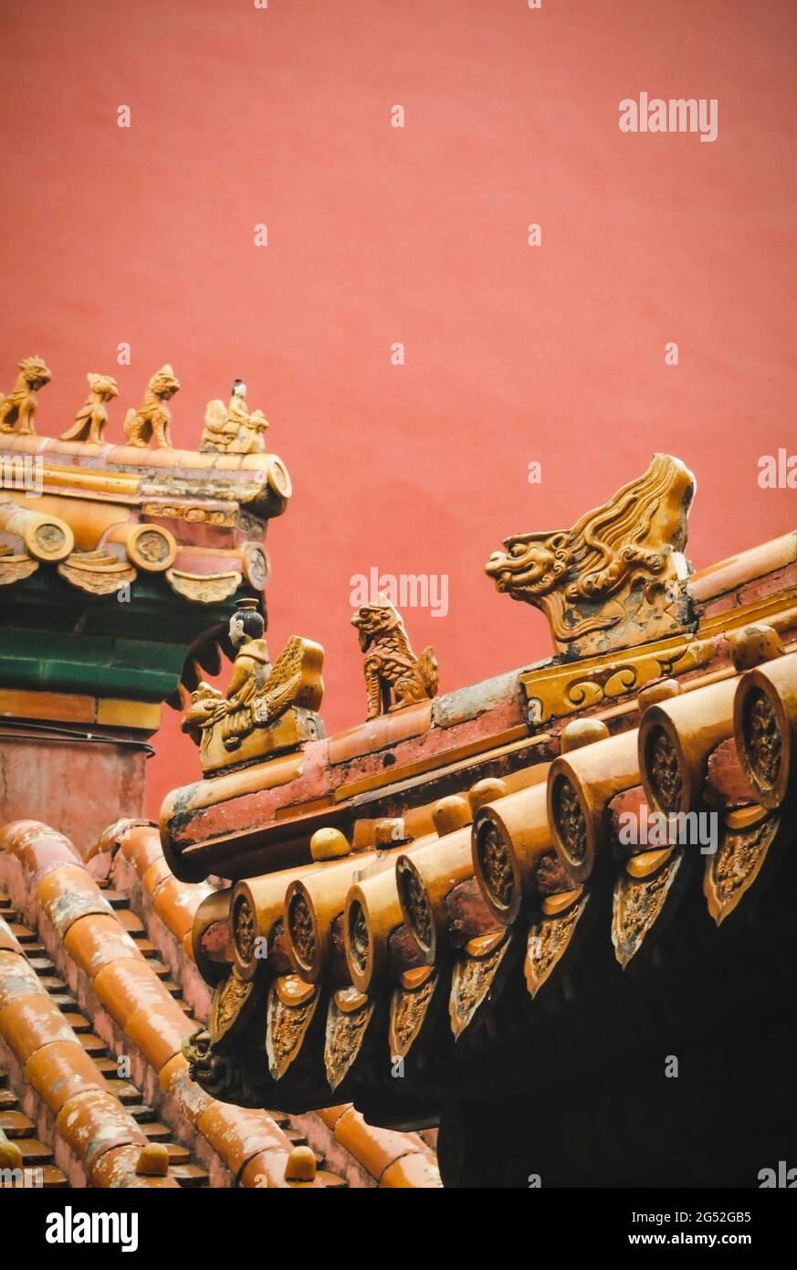 Detail of rooftop of palace building and red wall in the Forbidden City ...