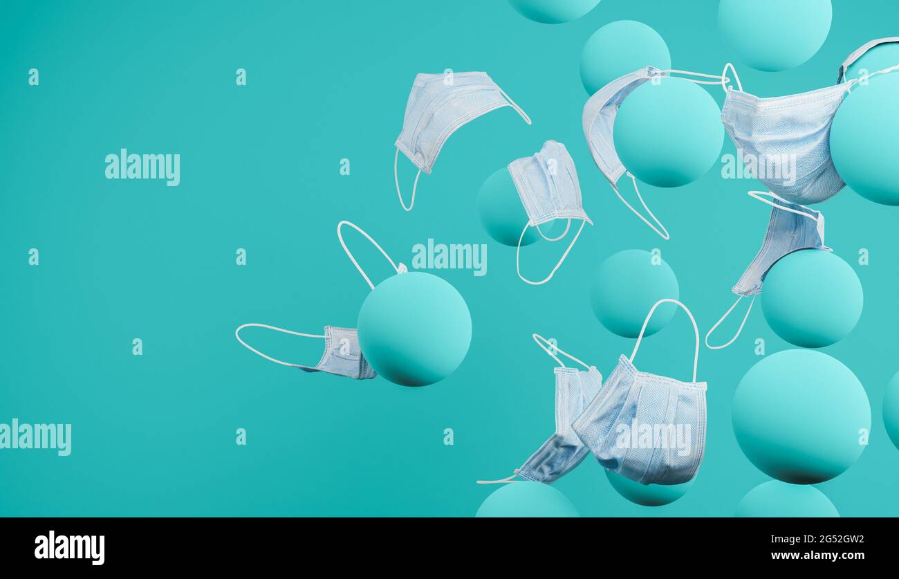 surgical masks falling on blue spheres. abstract and minimalist scene ...
