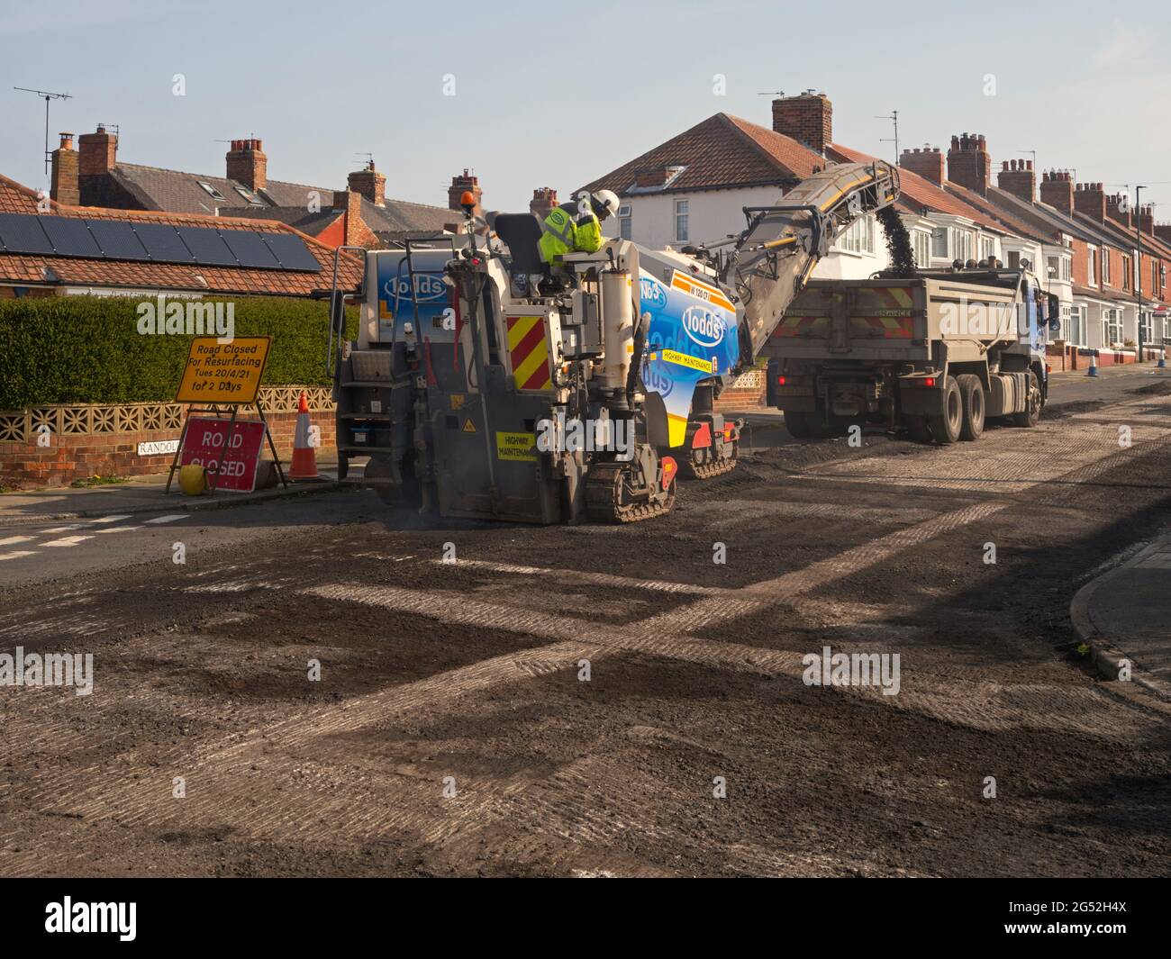 Road resurfacing, machines and vehicles stripping worn surface using ...