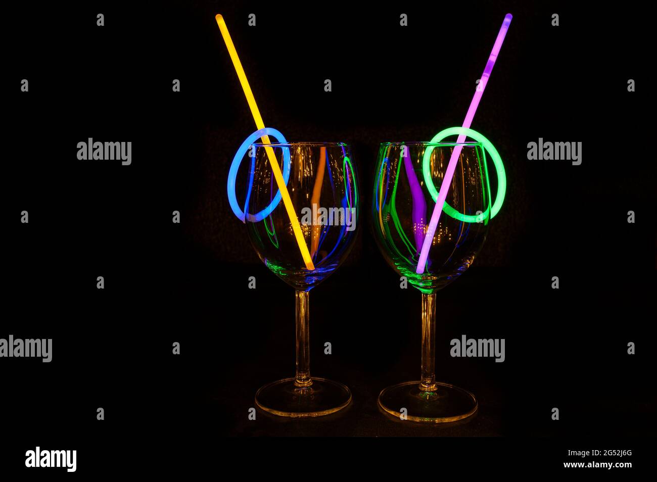 Holiday party in a bar wine glass colorful light reflection with dark ...