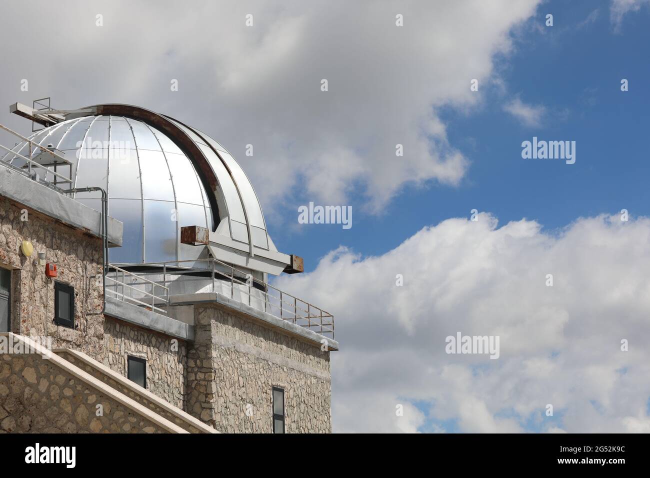large steel dome with the telescope of the astronomical observatory in ...